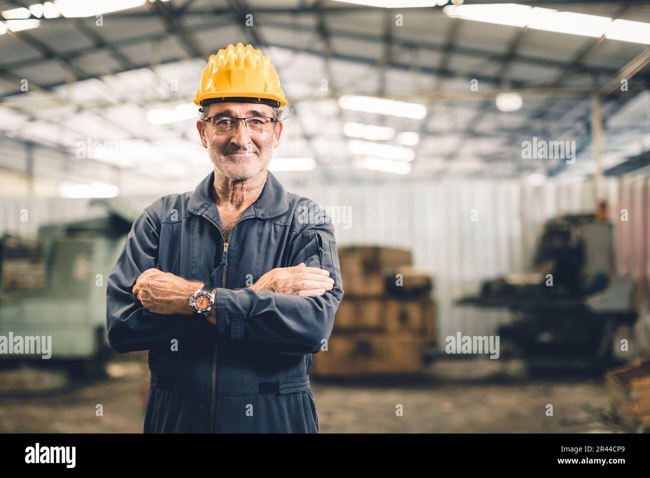 Senior high skill professional engineer male worker in heavy industry factory standing confident ...