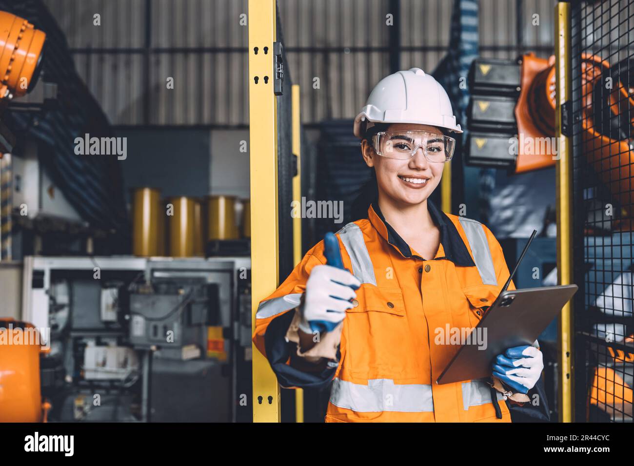 Engineer woman thumbs up working safety in modern automation factory ...
