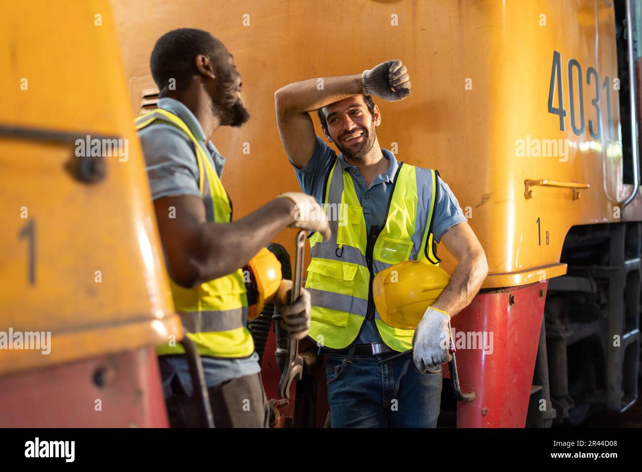 People working in heavy industry men at work happy workers laughing ...