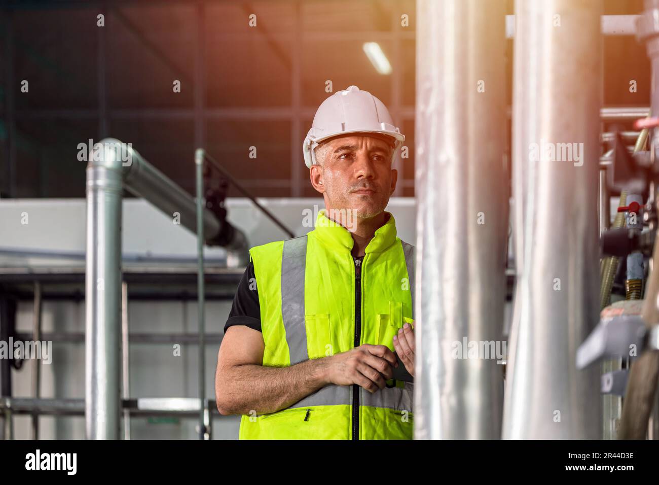 Factory engineer male worker checking high pressure pipe guage in ...