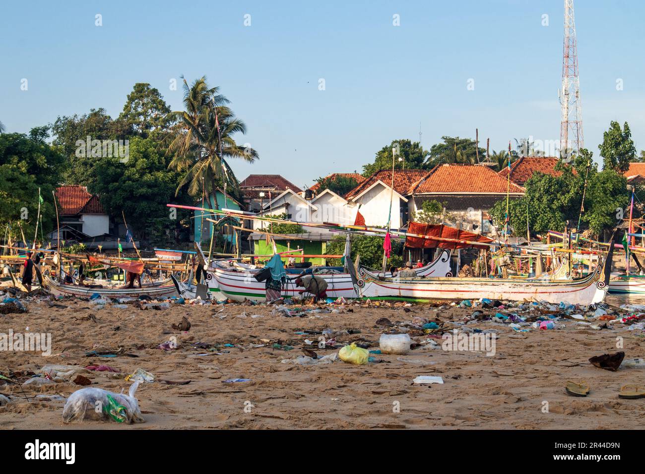 pile of garbage on the beach of the fishing area. Dirty sea, Black sand ...