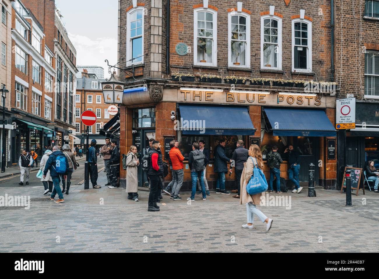 London, UK - April 13, 2023: People walking past The Blue Posts pub in ...