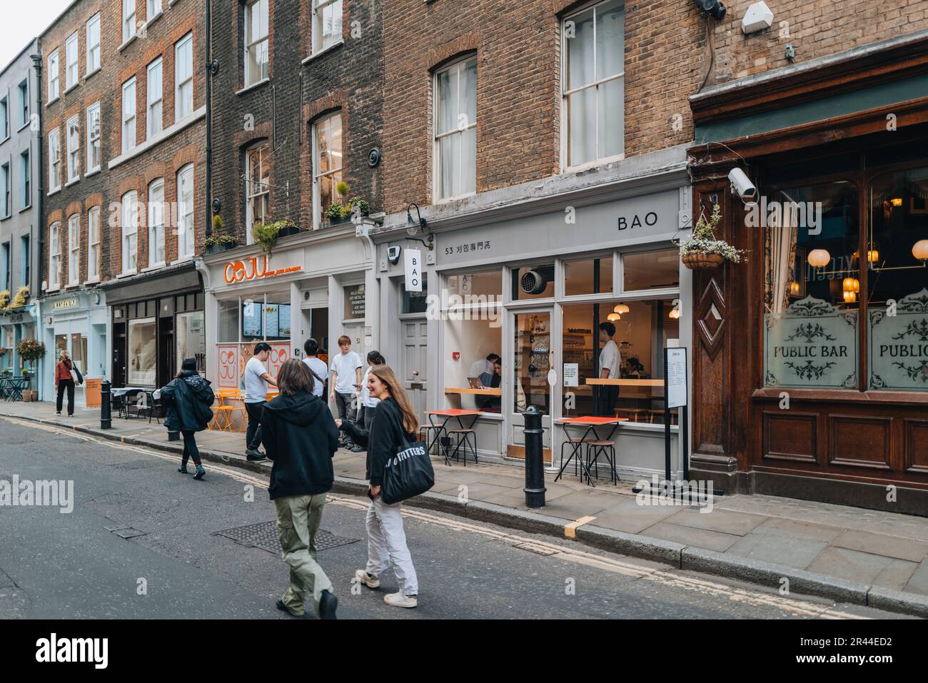 London, UK - April 13, 2023: Row of restaurants in Soho, an area of ...