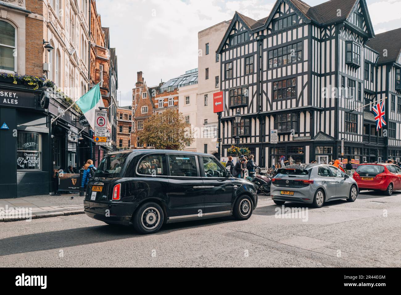 London, UK - April 13, 2023: Modern electric black cab on a street in ...