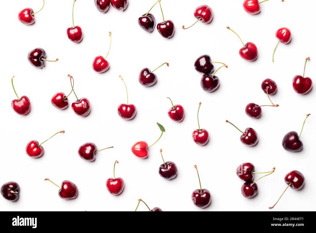 Set of red cherries isolated and separated from each other, on a white ...