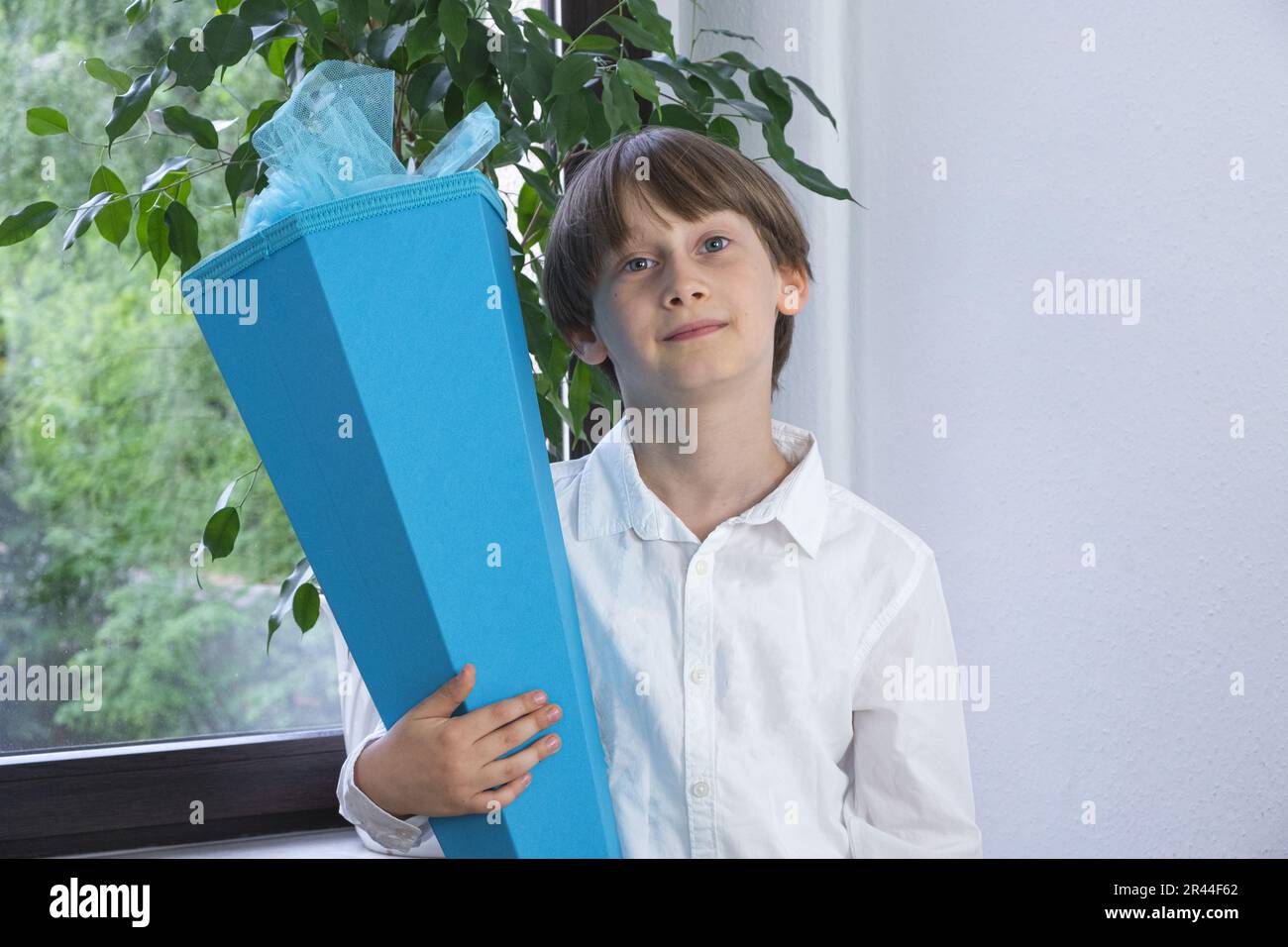 Happy child holding traditional German candy cone on the first school ...