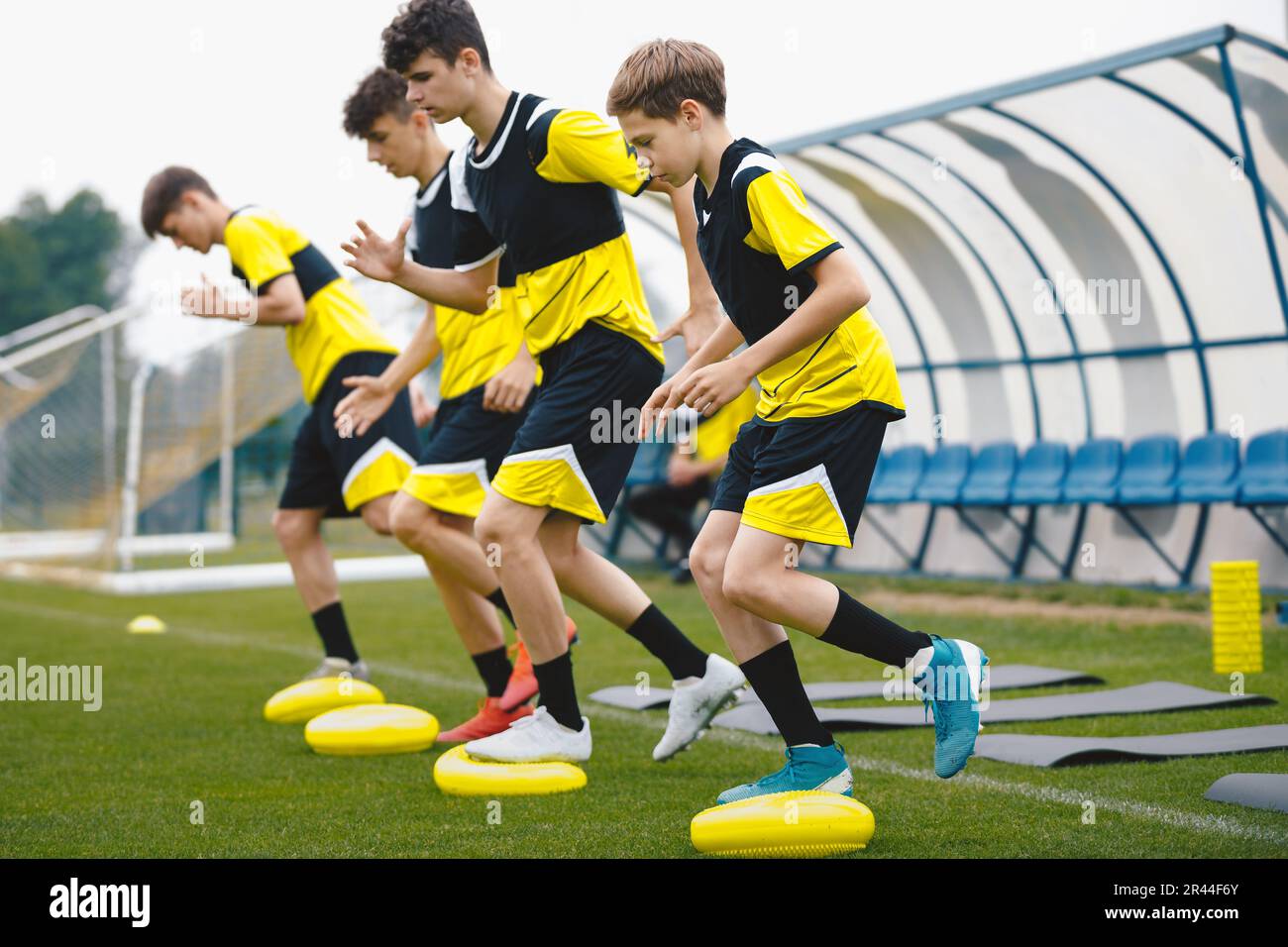 Sports Balance Training. Teenage Football Players Standing On Balance ...