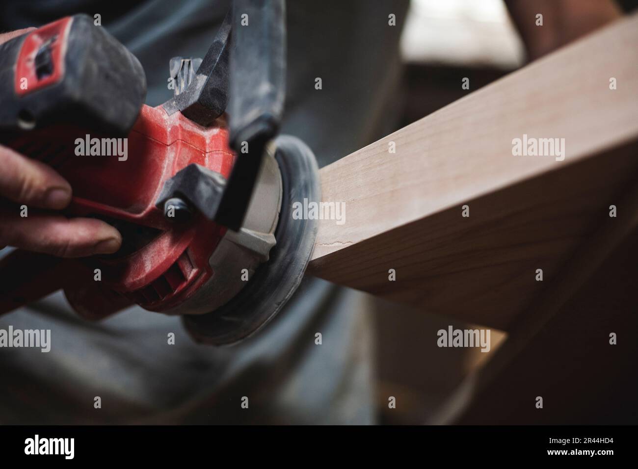 Enter the realm of perfection as a woodworker's hands meticulously work with a random orbital ...