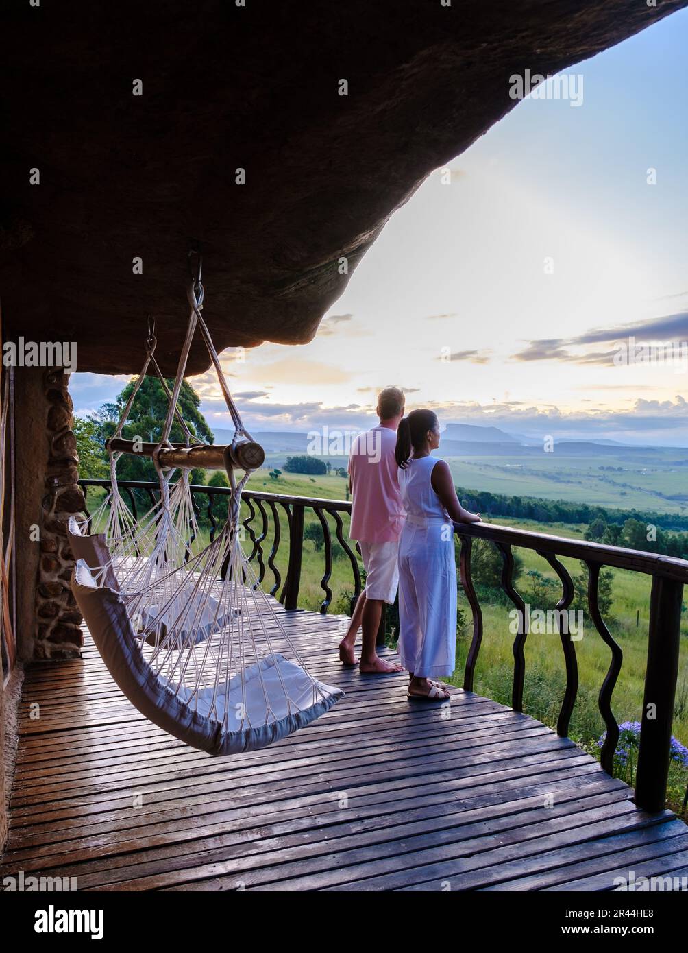 A couple of men and women on the terrace of a Lodge in the mountains ...