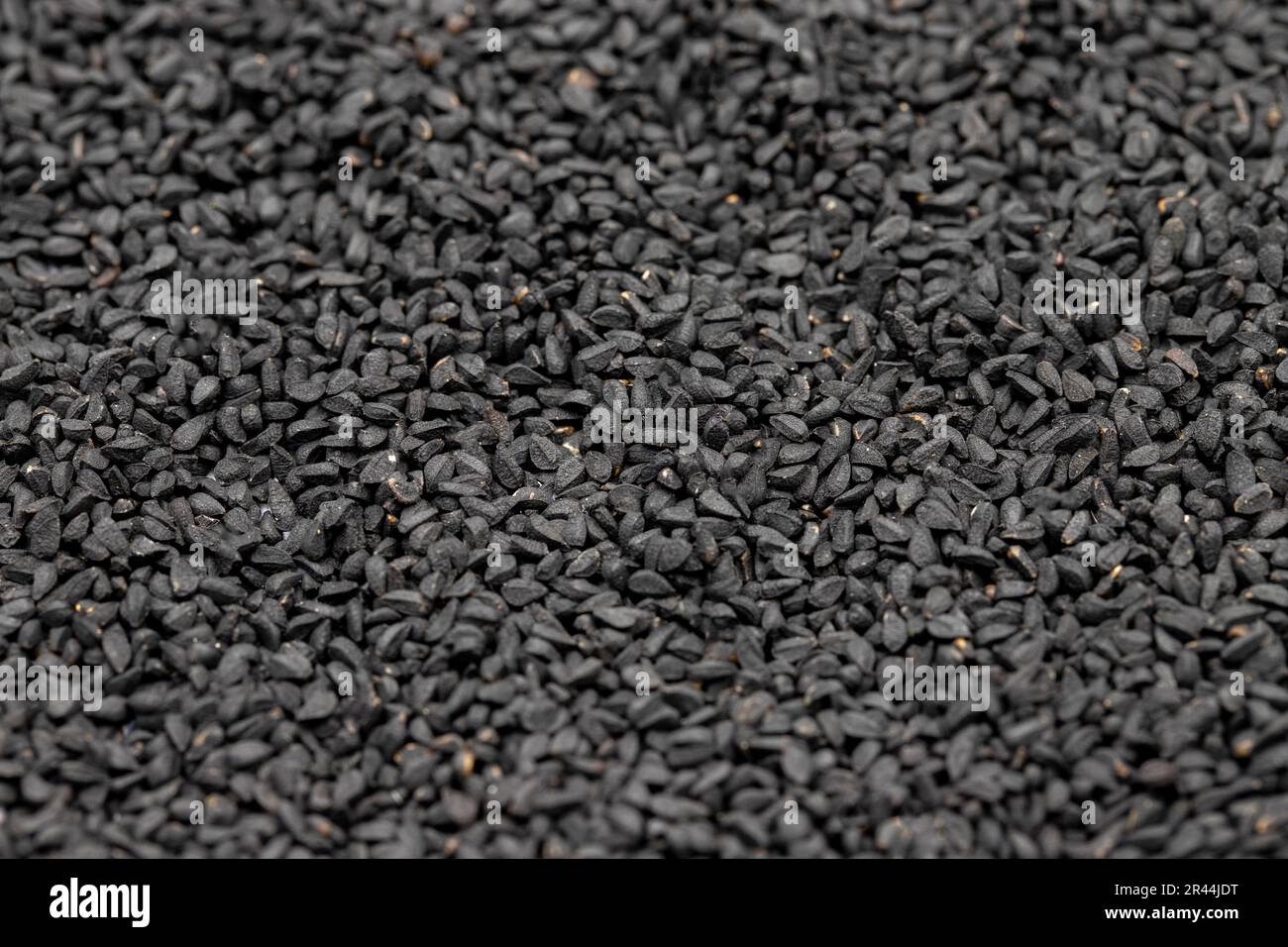 Pile of black cumin as background, spice or seasoning as background ...