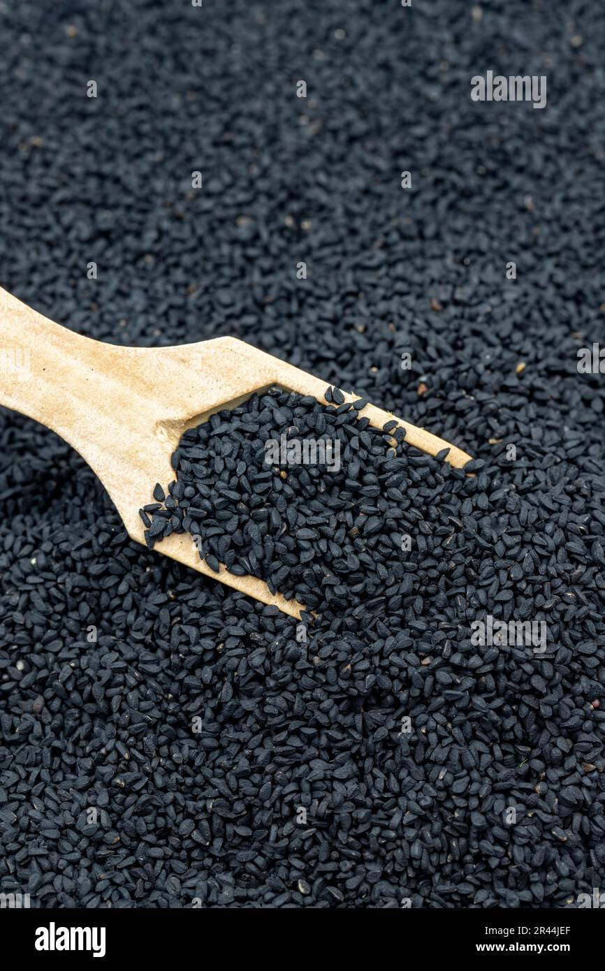 Pile of black cumin as background, spice or seasoning as background ...