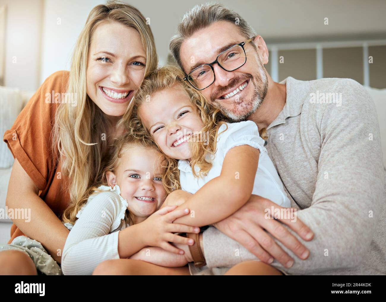 Parents, portrait and sofa with hug, kids and smile with love, bonding ...