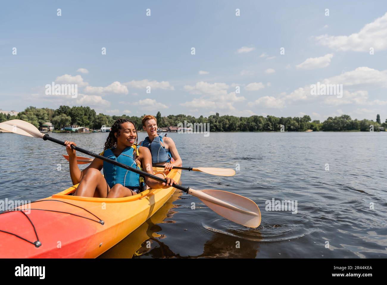 carefree and charming african american woman and young redhead man in ...