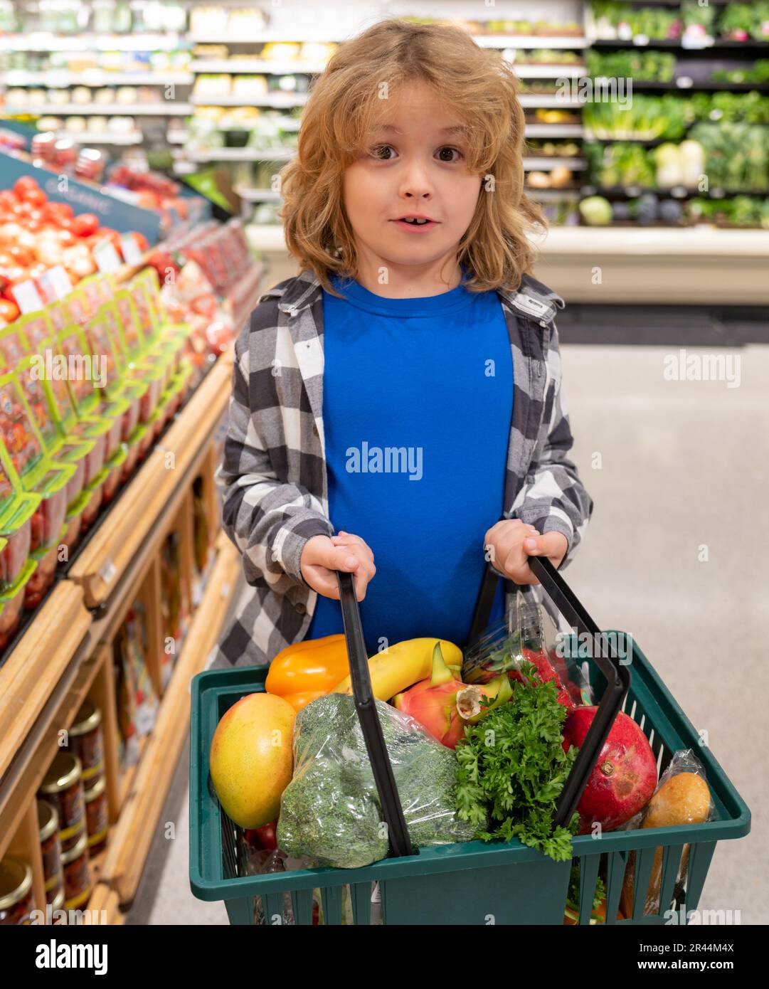 Happy little kid with fruits and vegetables at grocery store. Healthy ...