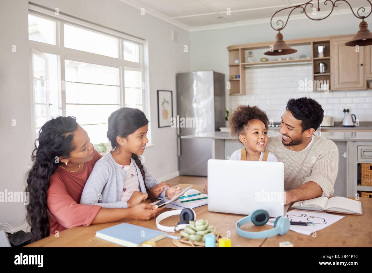Online school, laptop and parents with their children in the dining ...