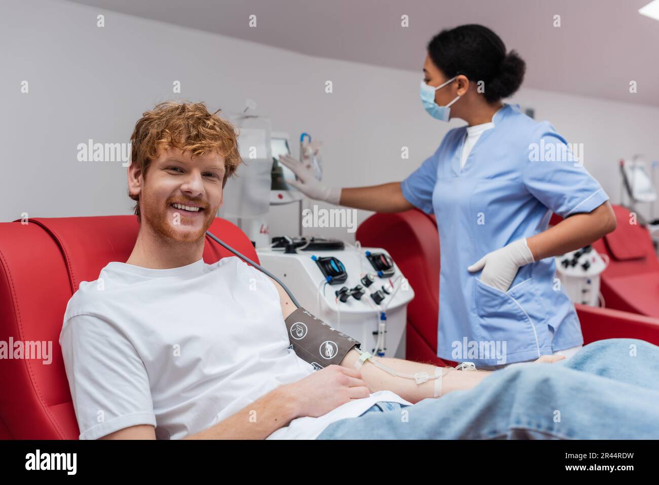 multiracial nurse in medical mask and latex gloves operating ...
