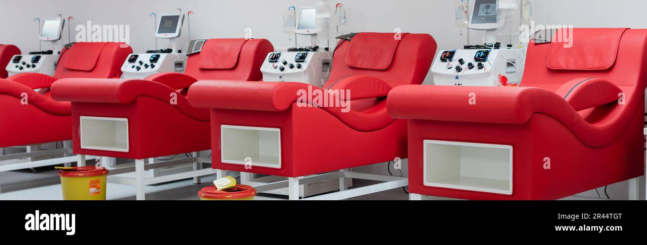 row of comfortable medical chairs with ergonomic design, trash buckets ...