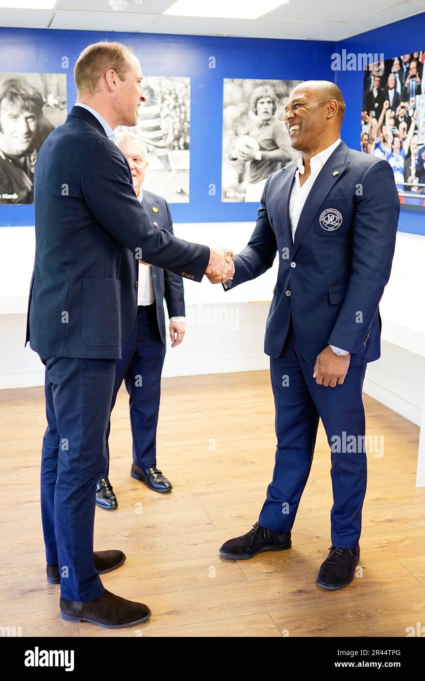 Britain's Prince William, left, shakes hands with former soccer player ...