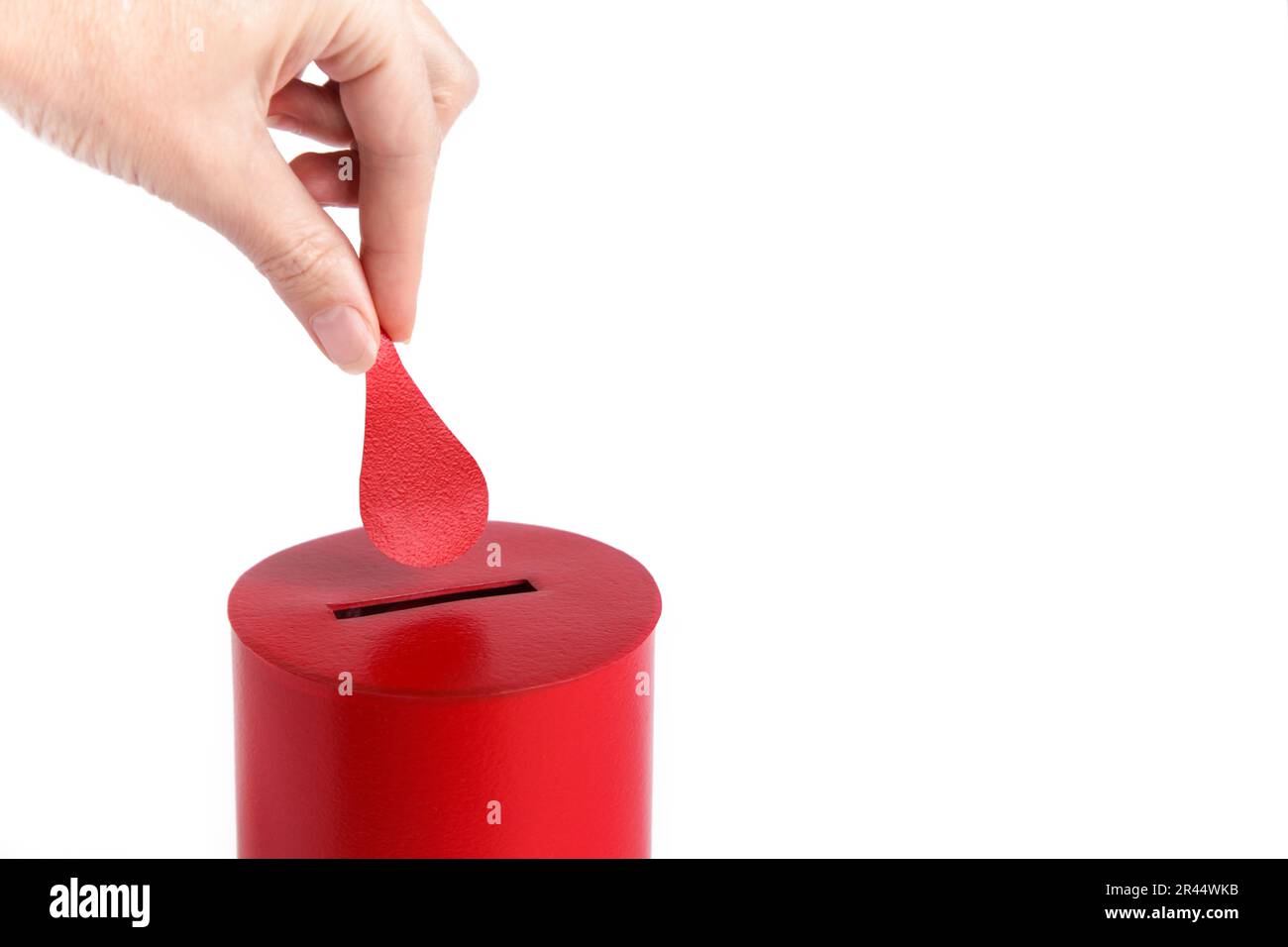 Blood donor. Hand puts drop of blood in the Box as donation on white ...