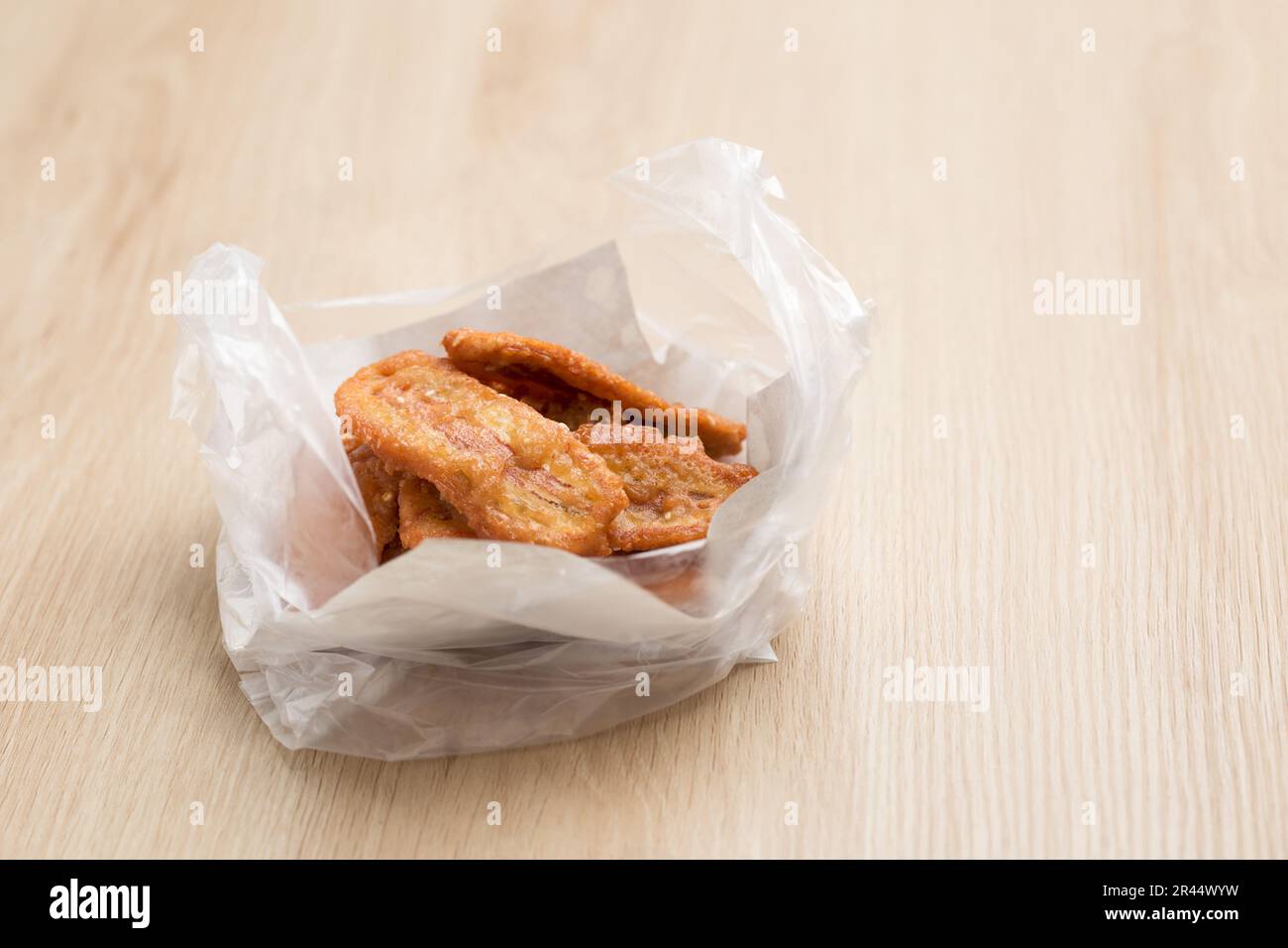 Kluay Khak or Kluay Tod ( Banana dipped ) in fried flour and packed in ...