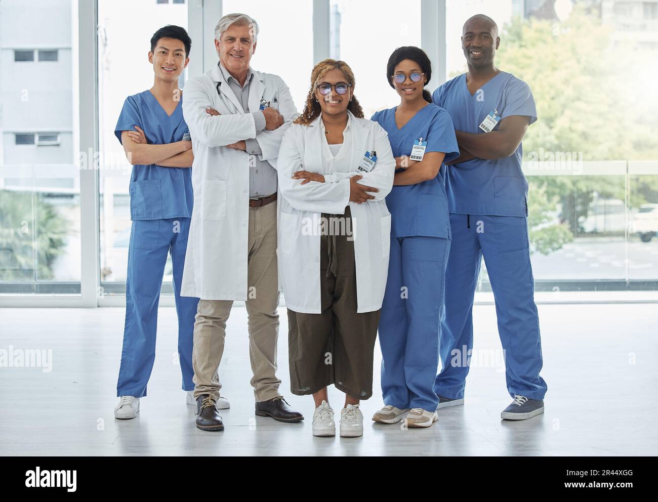 Leadership portrait, doctors and nurses with arms crossed standing together in hospital. Face ...