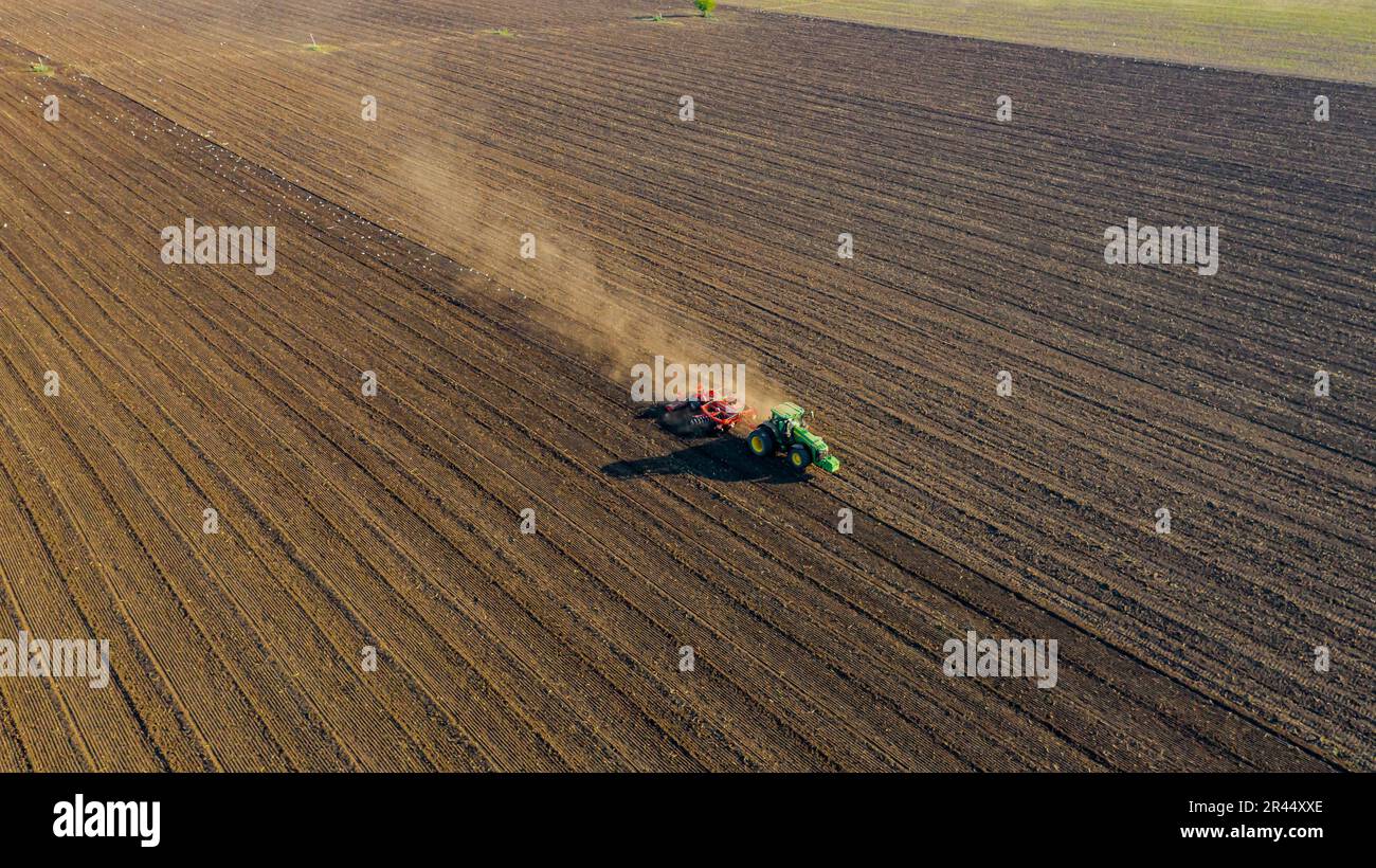 Above view, tractor pull disc harrow, harrowing farmland, preparing ...