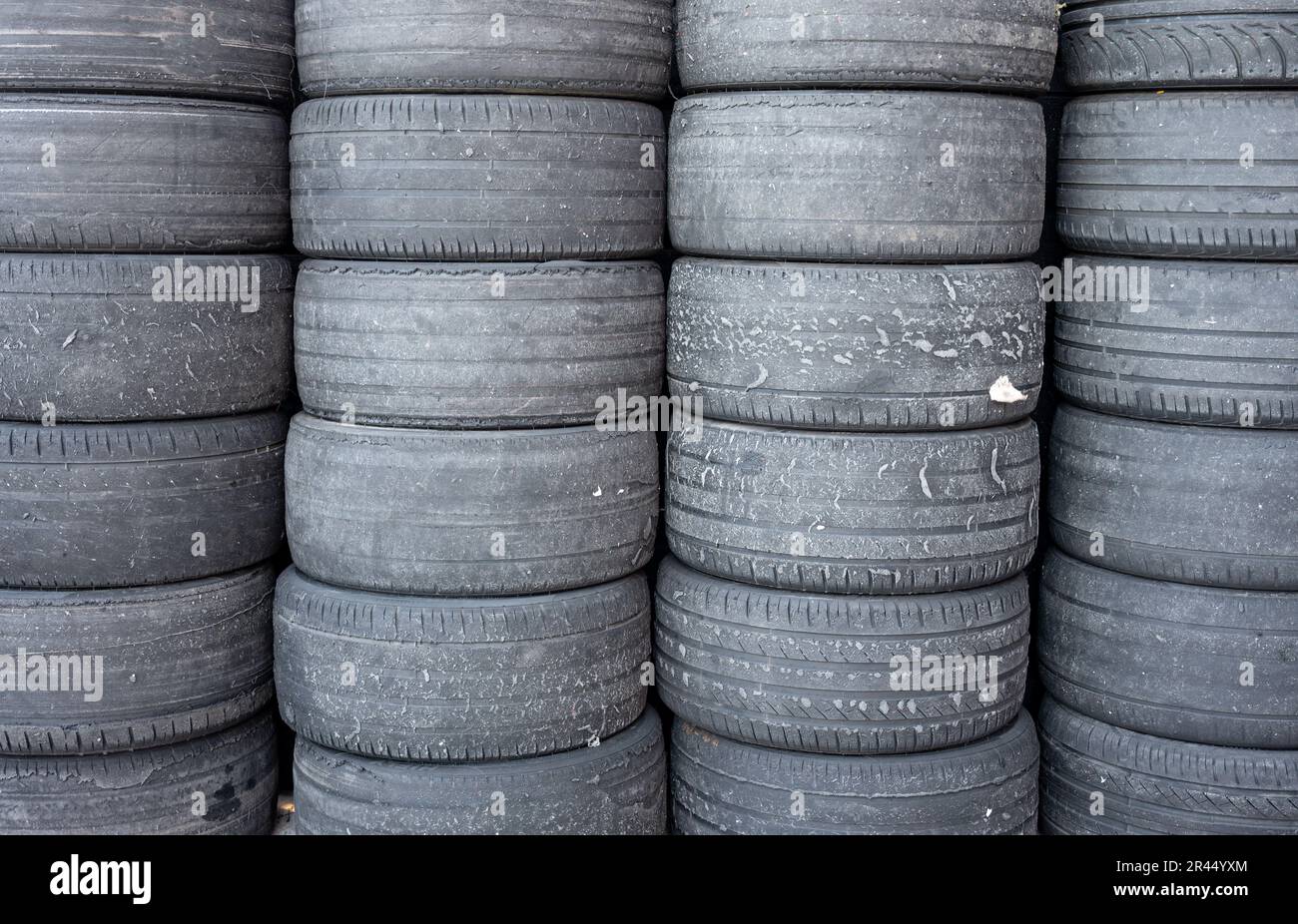 A pile of stacked worn racing car tires Stock Photo - Alamy