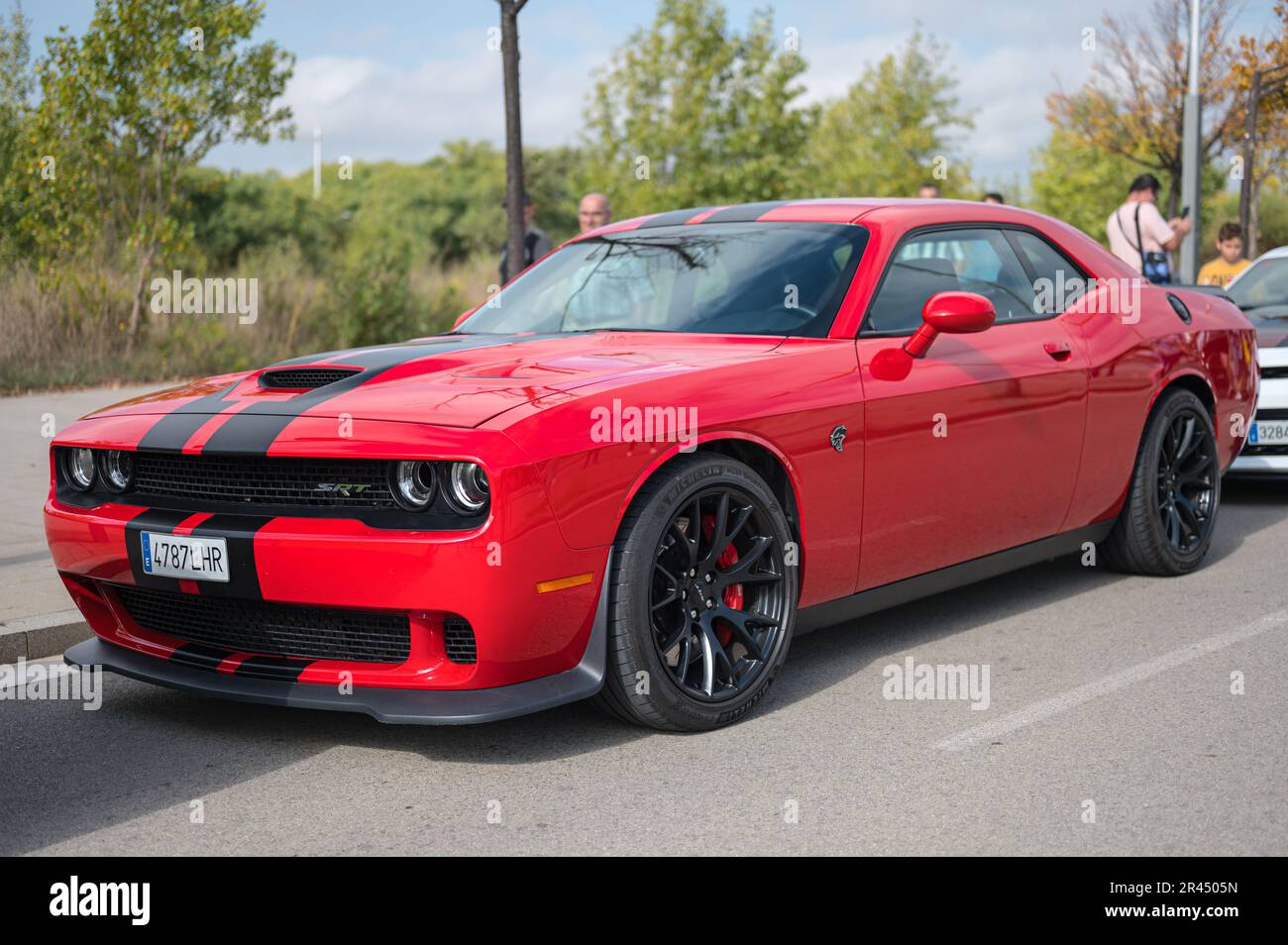 Front view of a nice red Dodge Challenger SRT with two black lines ...