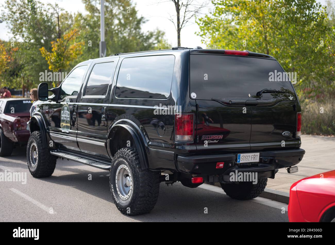 Rear view of a large American SUV, it is a black Ford Excursion parked ...