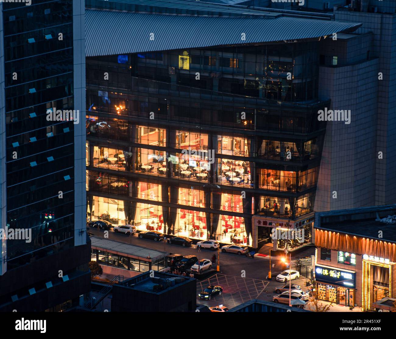An aerial view of a modern restaurant with wide windows at the night ...