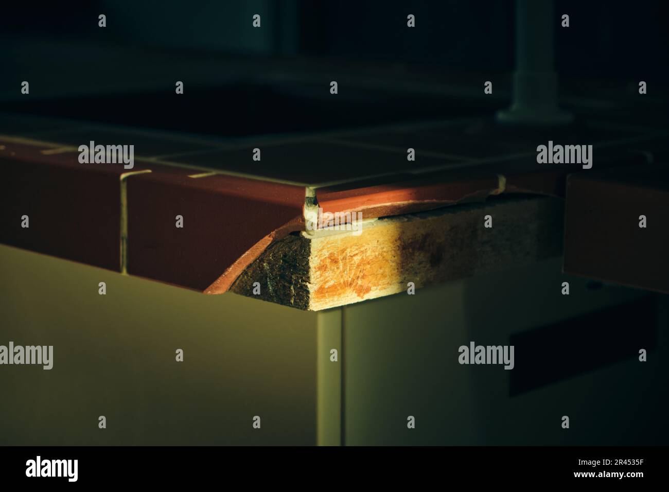 A closeup of an aged table surface with a damaged edge Stock Photo - Alamy