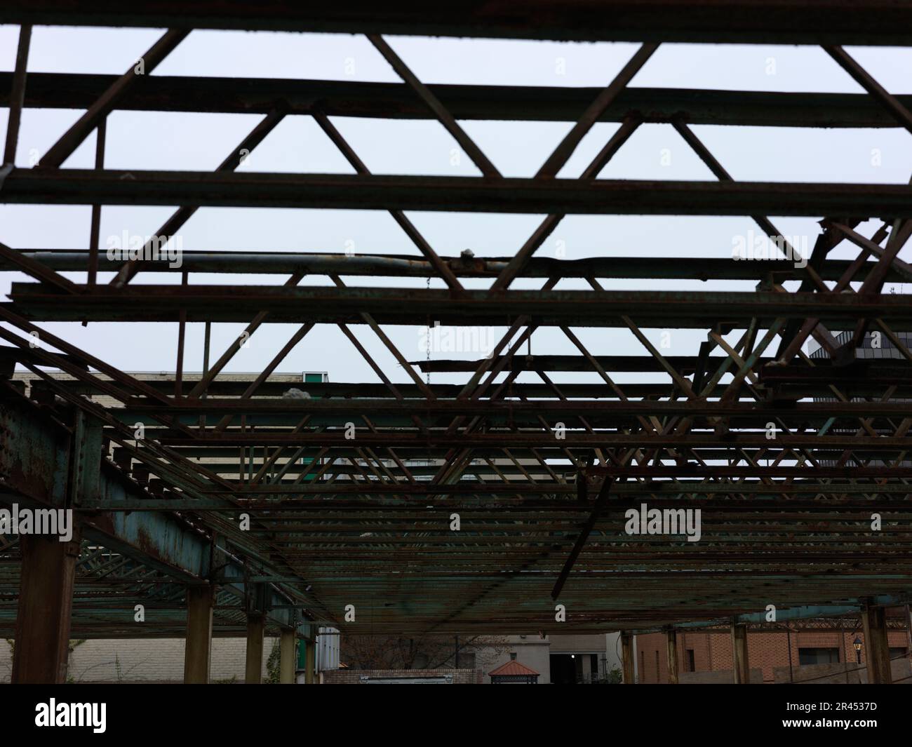 A desolate, corroded iron structure sits abandoned in a field Stock ...