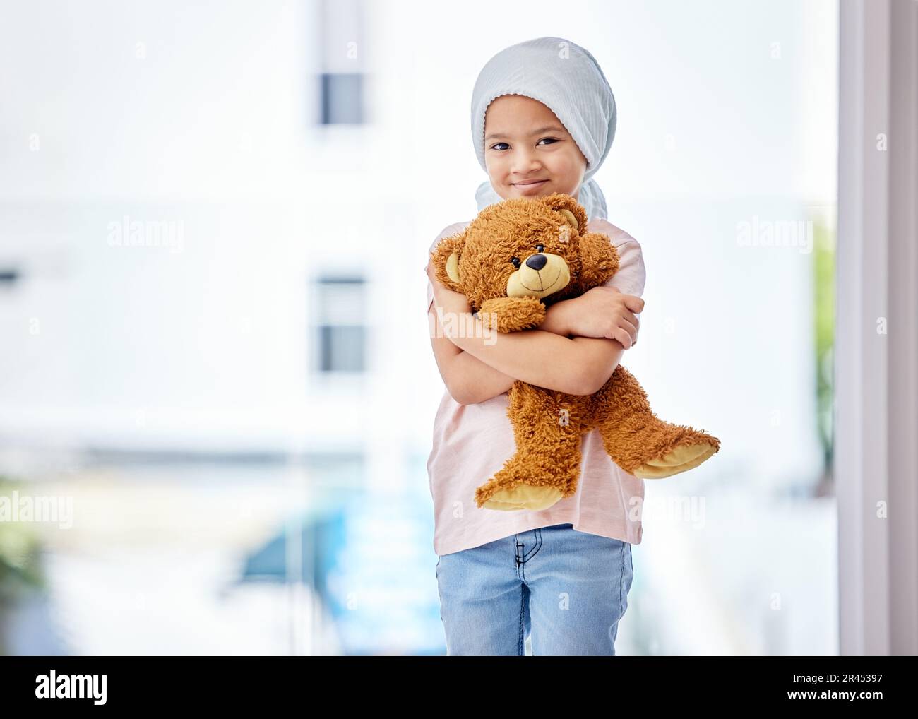 Healthcare, child and portrait of a cancer patient holding a teddy bear ...