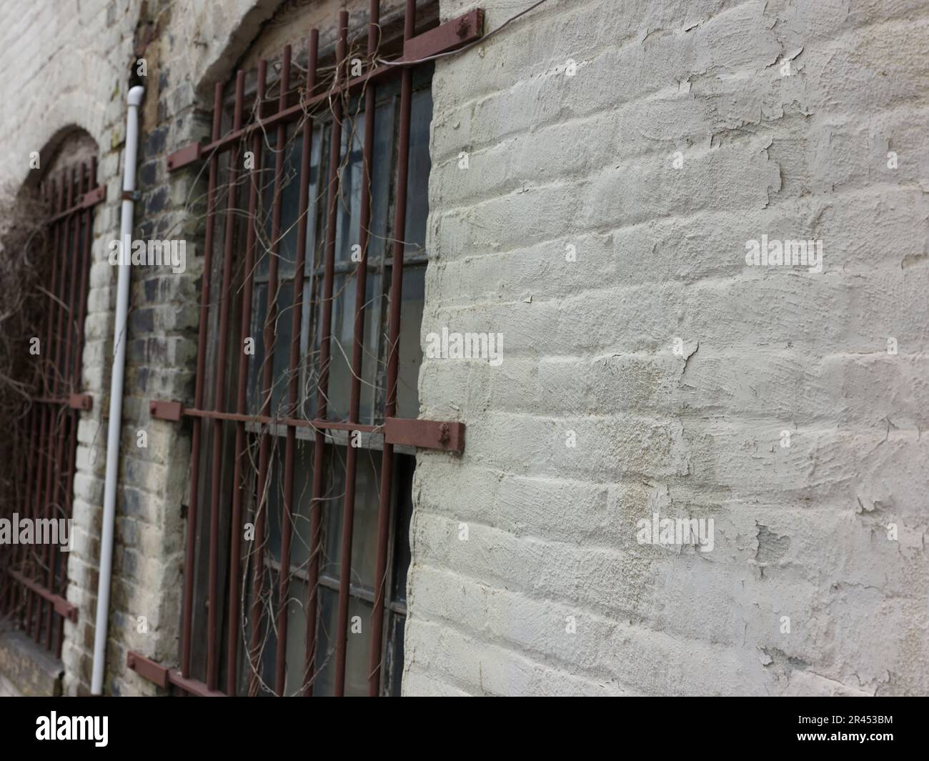 An aged, metal window frame is featured in this image, with its ...