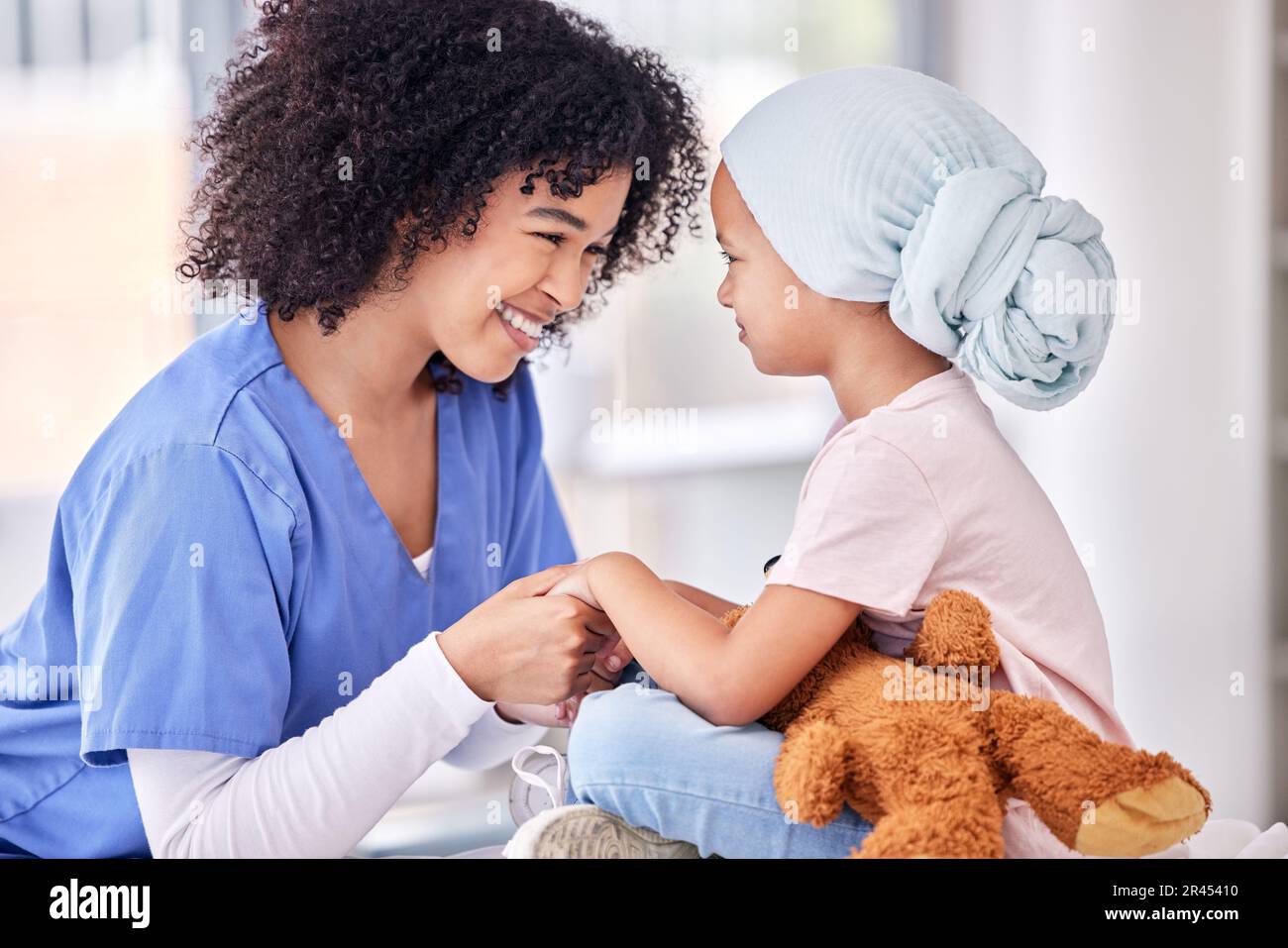 .Support, nurse and child holding hands on bed in hospital for children ...
