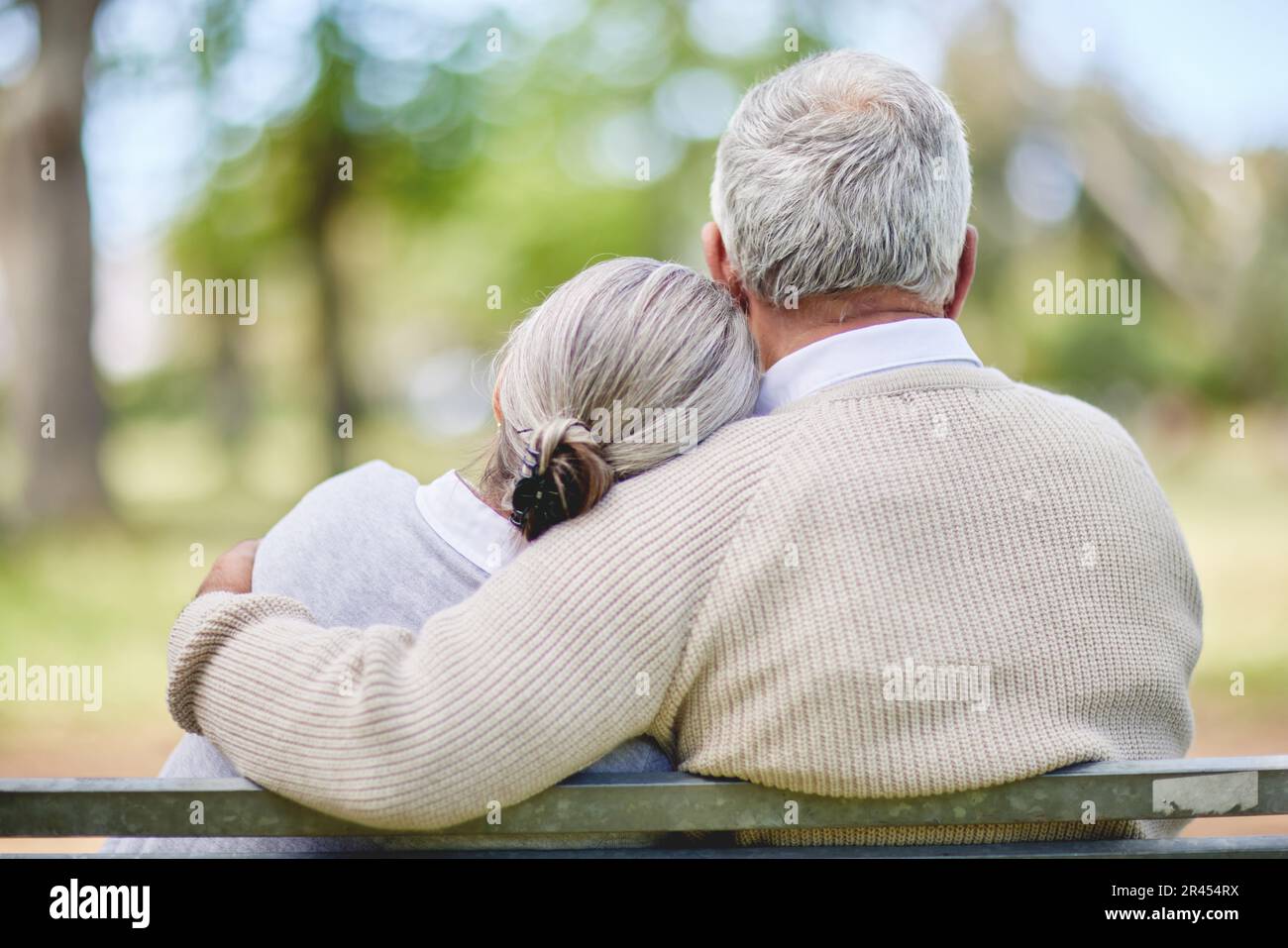 Back view of old couple, hug in park with love and view of nature ...