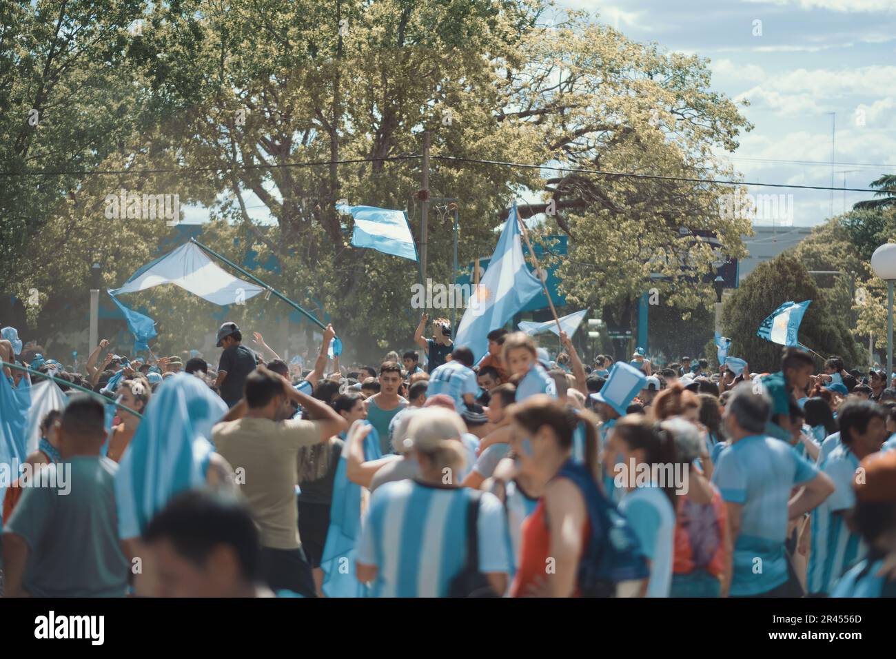 A crowd of Argentinian fans celebrating and cheering in joy after their ...