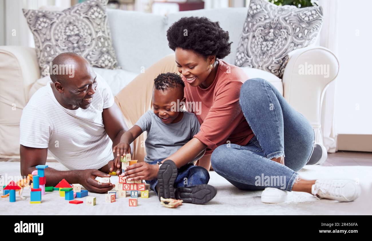 Building blocks, toys and black family playing on a living room floor ...