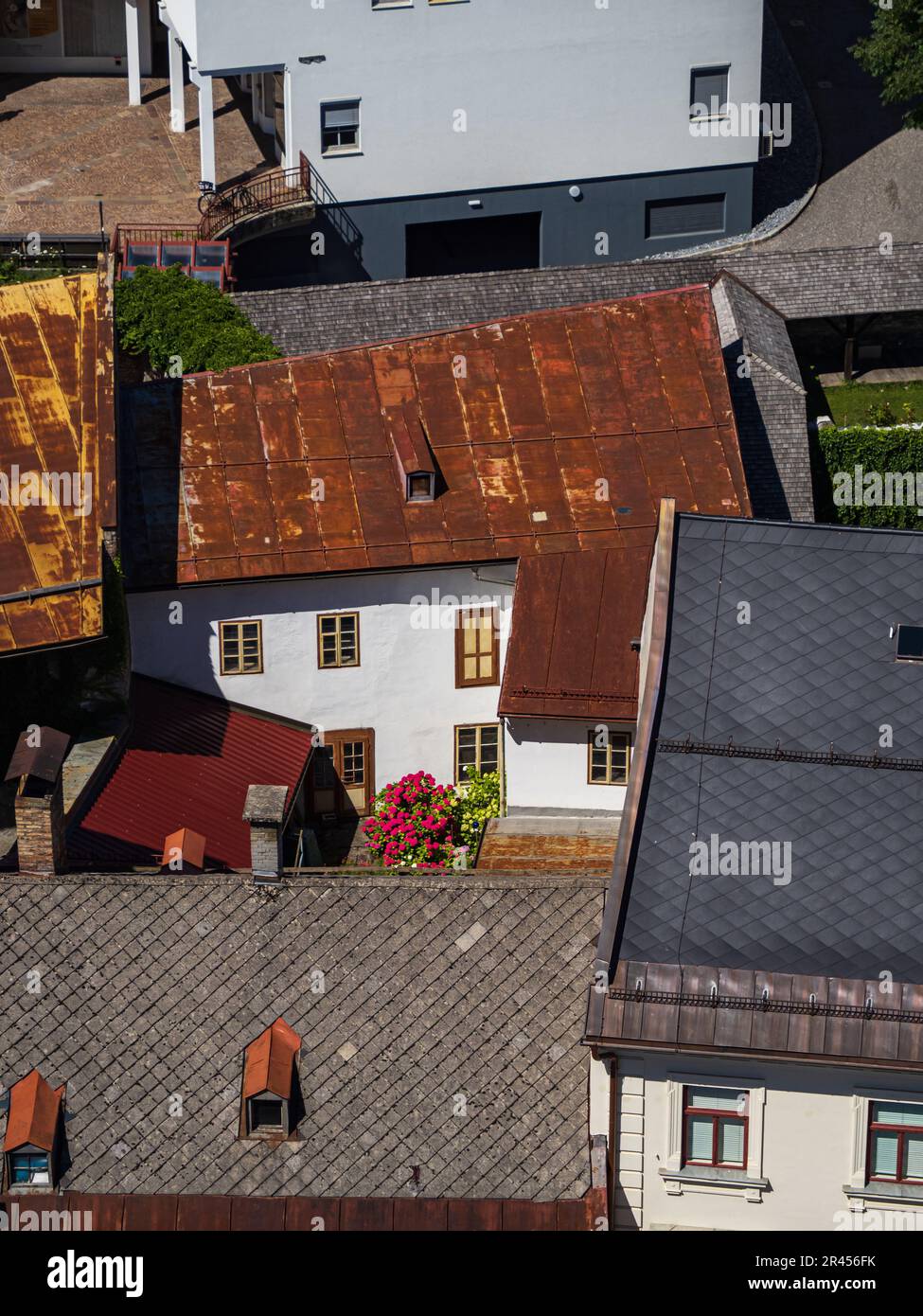 Aerial view of old medieval houses with white walls and rusty rooftops ...
