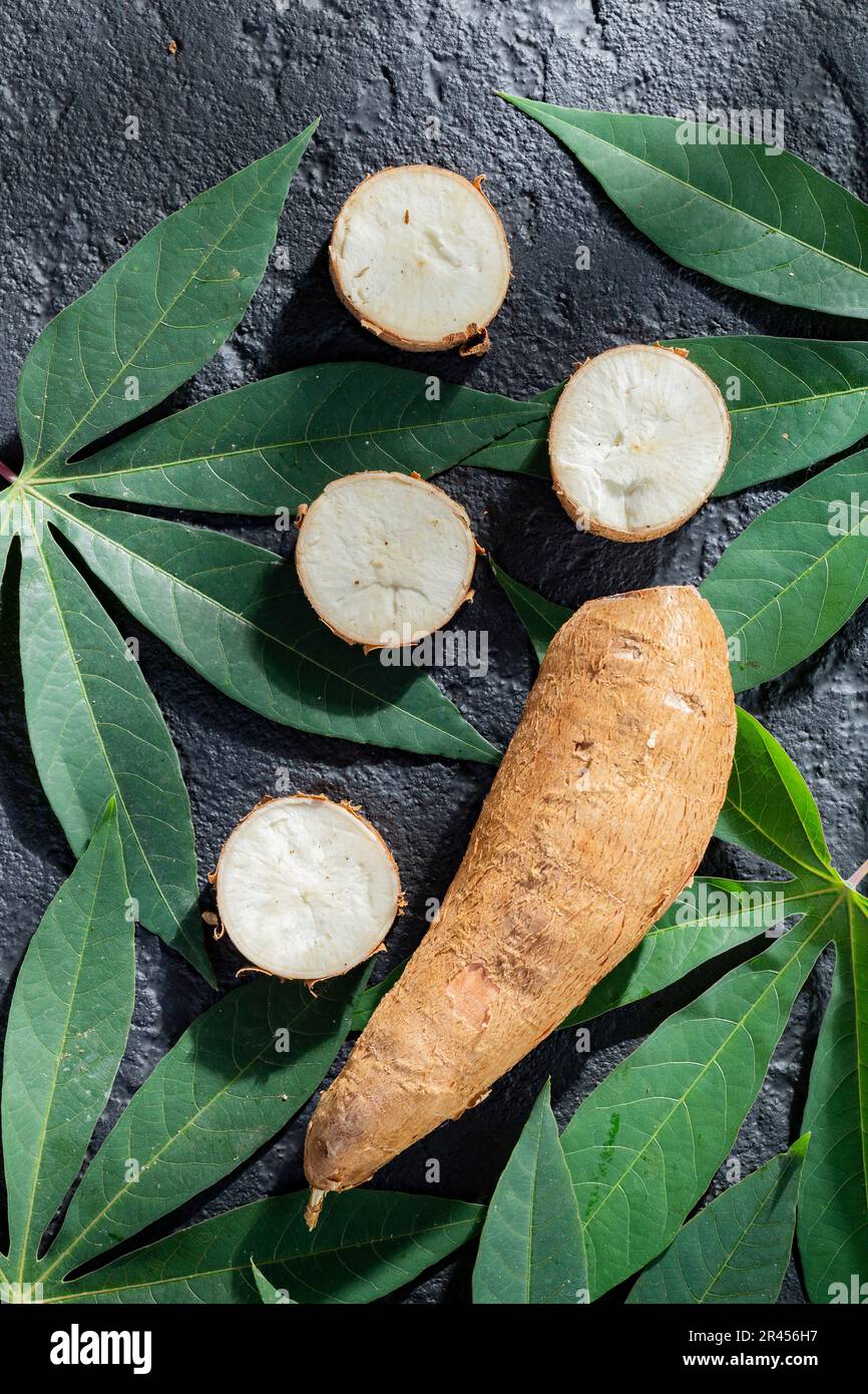 pile of cassava fruit and cassava flour on a background of rustic and ...