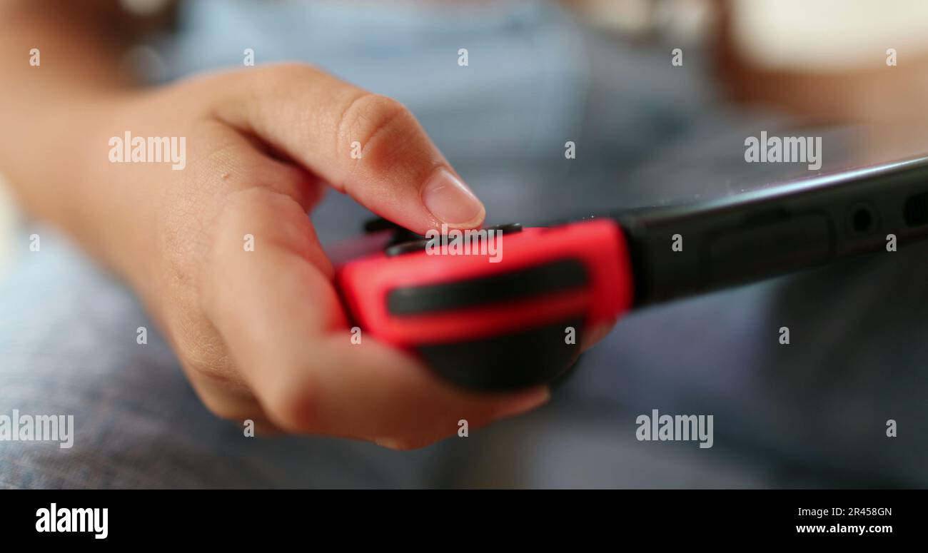Child hands playing video-game with controller. Close-up kid hand ...