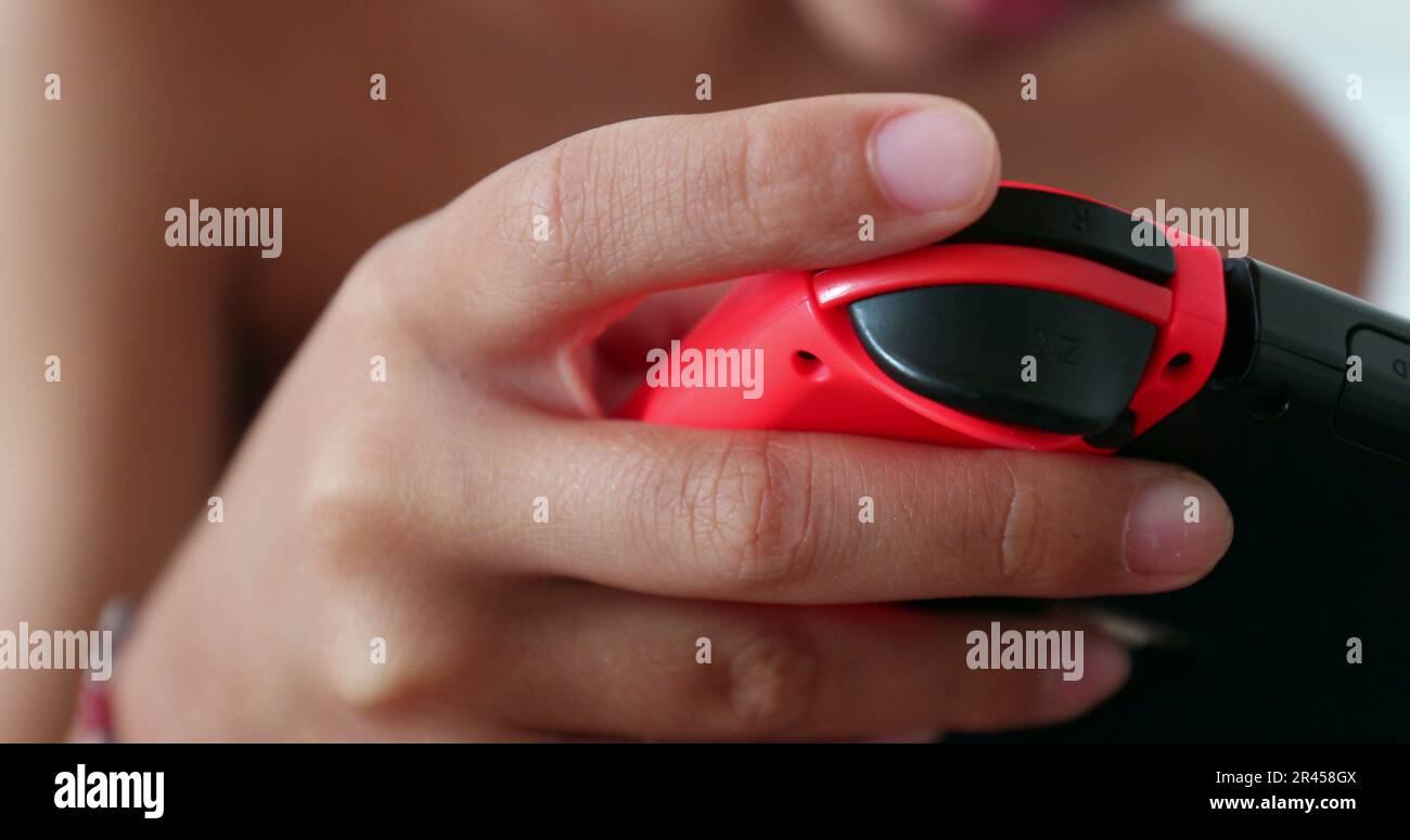 Child playing game on joystick device controller Stock Photo - Alamy