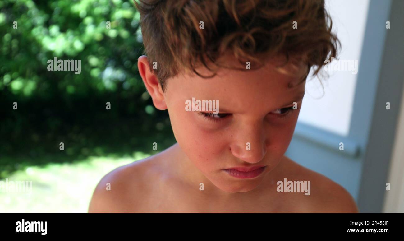 Angry young boy face feeling distraught and upset Stock Photo - Alamy