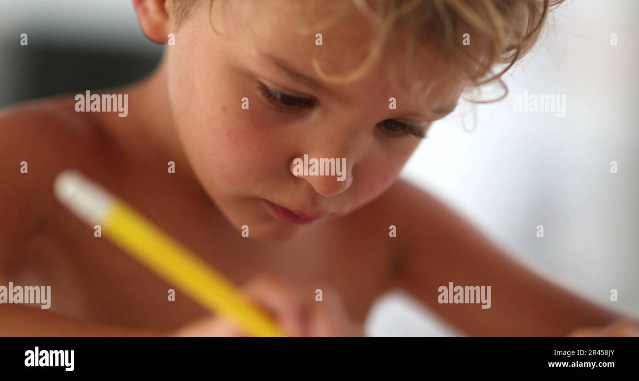 Child hand drawing on paper. Concentrated artistic kid skething with ...