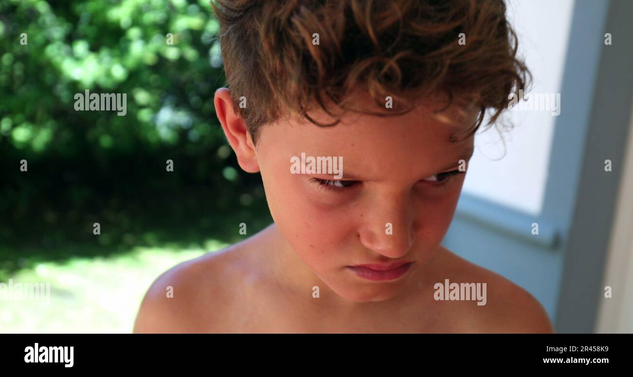 Angry young boy face feeling distraught and upset Stock Photo - Alamy