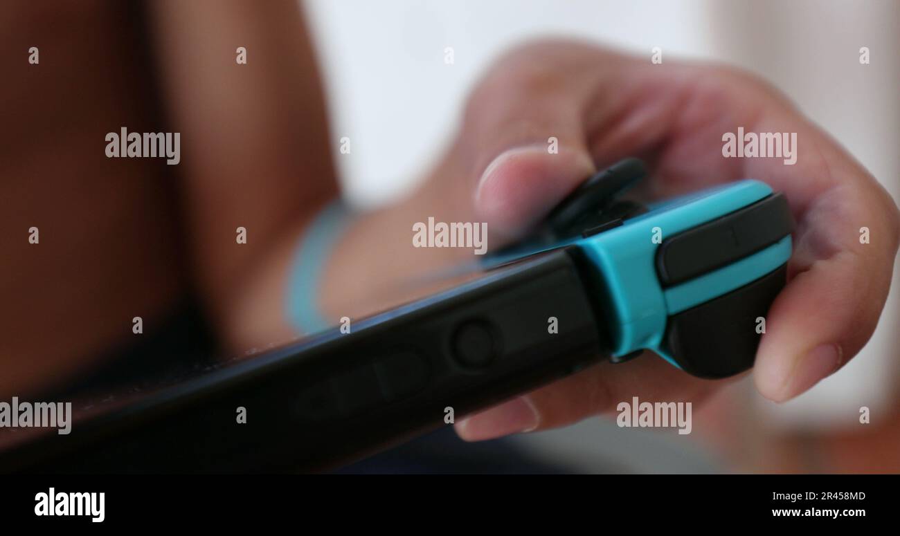 Child hands holding controller playing game, kid addicted to video-game ...
