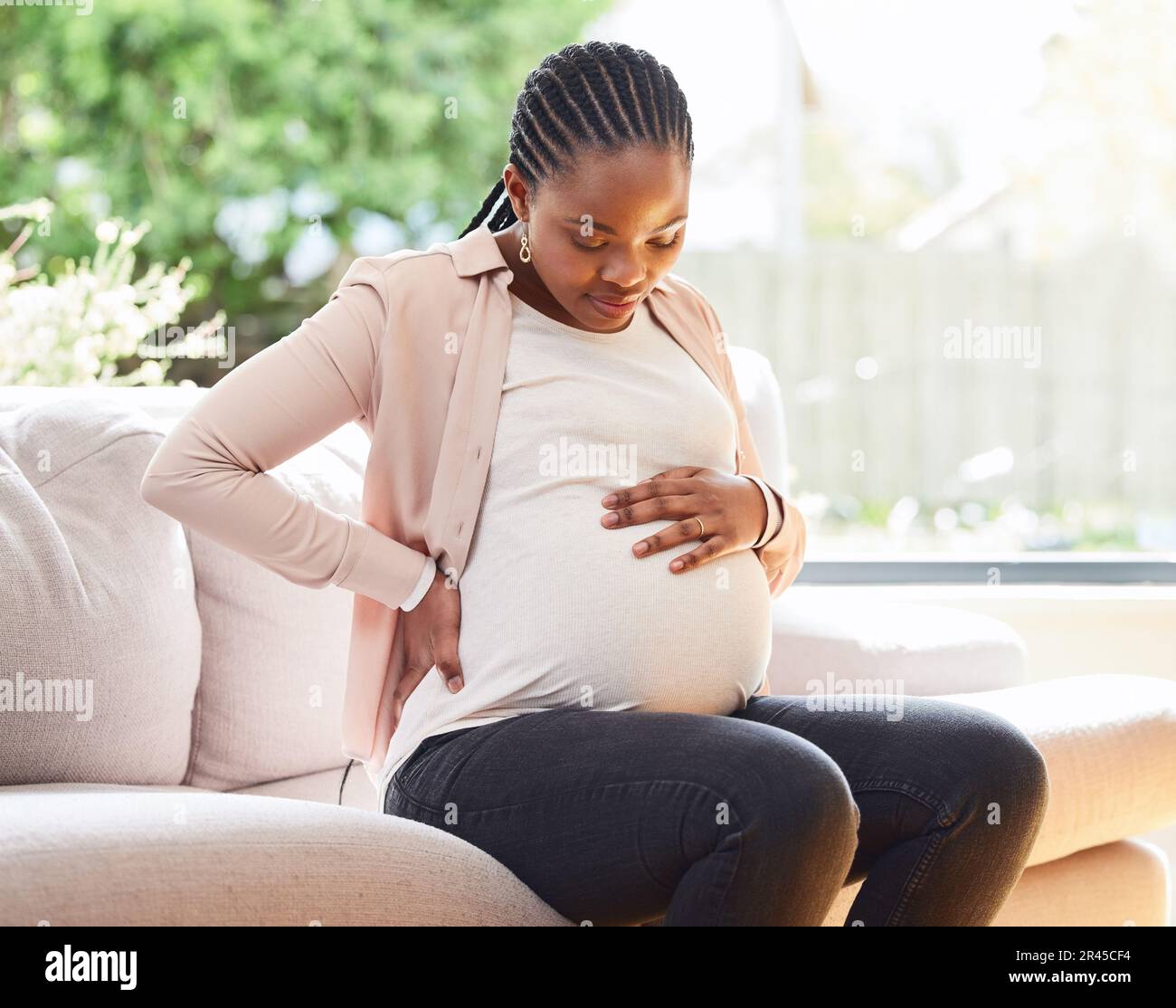 Back pain, stomach and relax with pregnant woman on sofa for labor ...