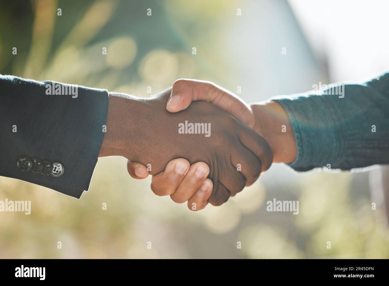 Thank you, men shaking hands for agreement and networking with a lens ...