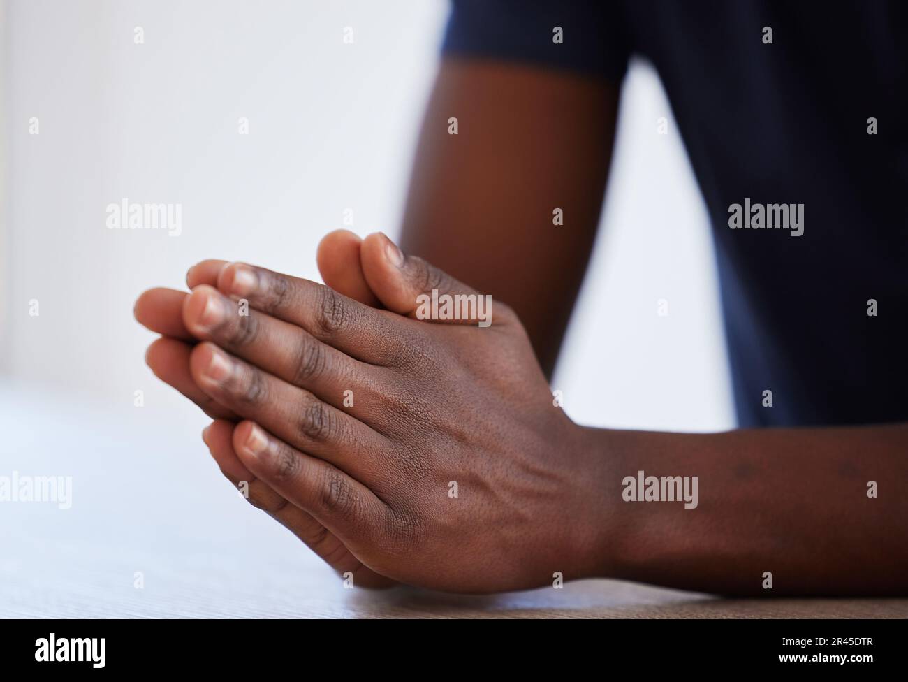 Worship, hands and man praying in studio in hope of help, guidance and ...