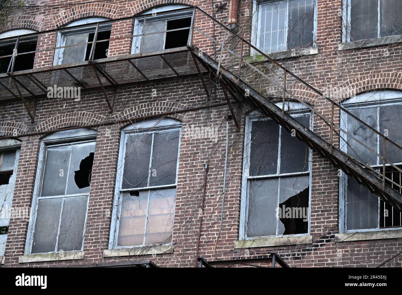 An exterior of an old building in an urban area with arched windows ...